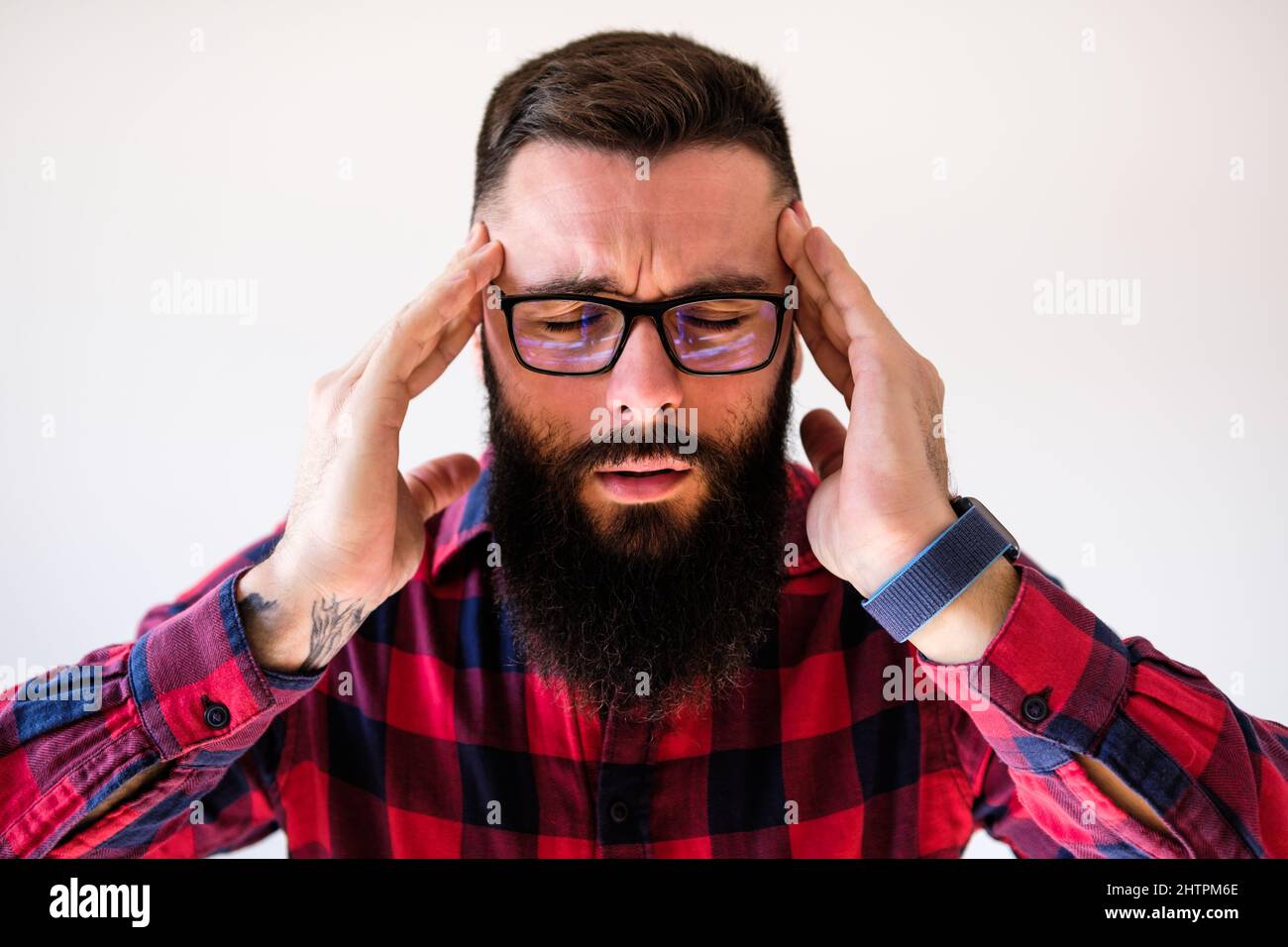 Portrait of man who is tired and having headache. Copy space on image ...