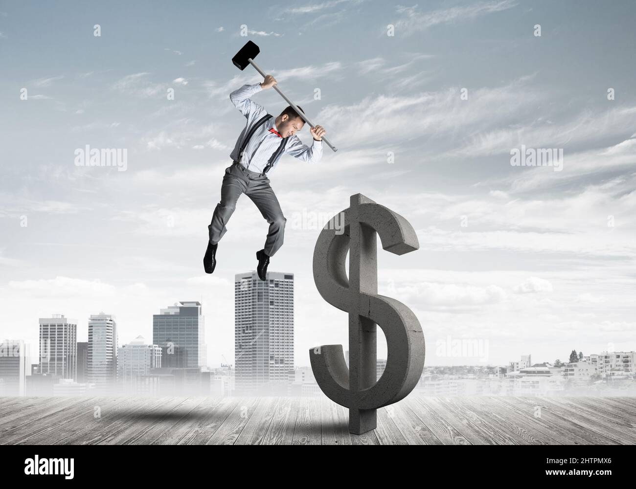 Determined banker man against modern cityscape breaking dollar concrete ...