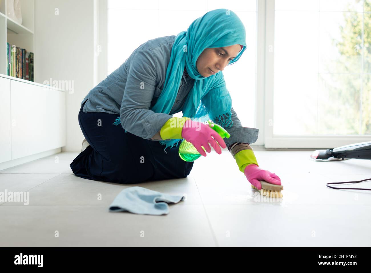 Happy Muslim Woman Cleaning Modern House Living Room. High quality ...