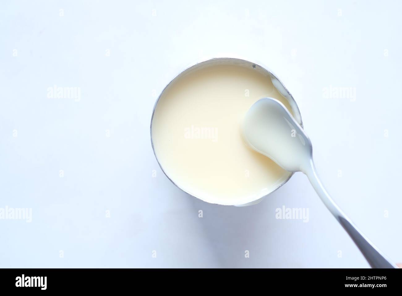 condensed milk in a bowl close up Stock Photo - Alamy