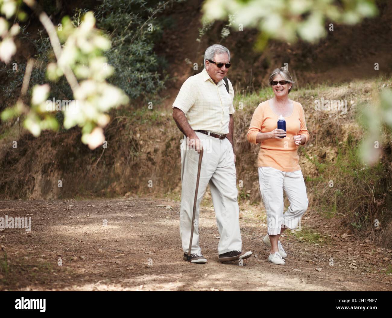 Stretching Their Legs On A Leisurely Stroll A Senior Couple Out For A Walk In The Forest
