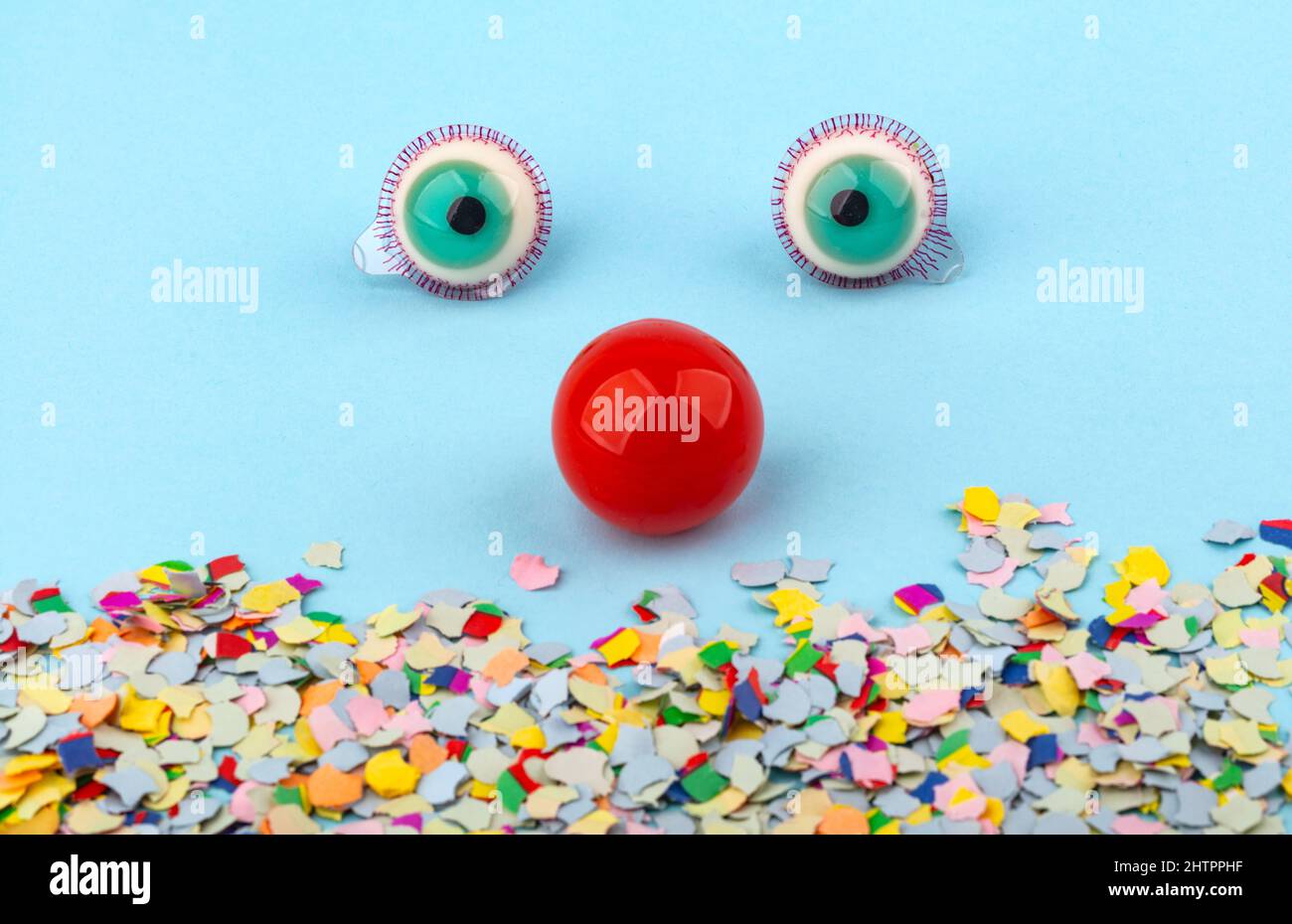 Red Nose with confetti over light blue background. Conceptual Photo to ...