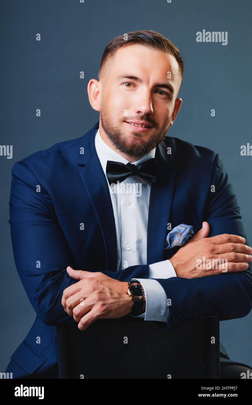 Caucasian man of 30-35 years old in business classic suit sits on chair ...