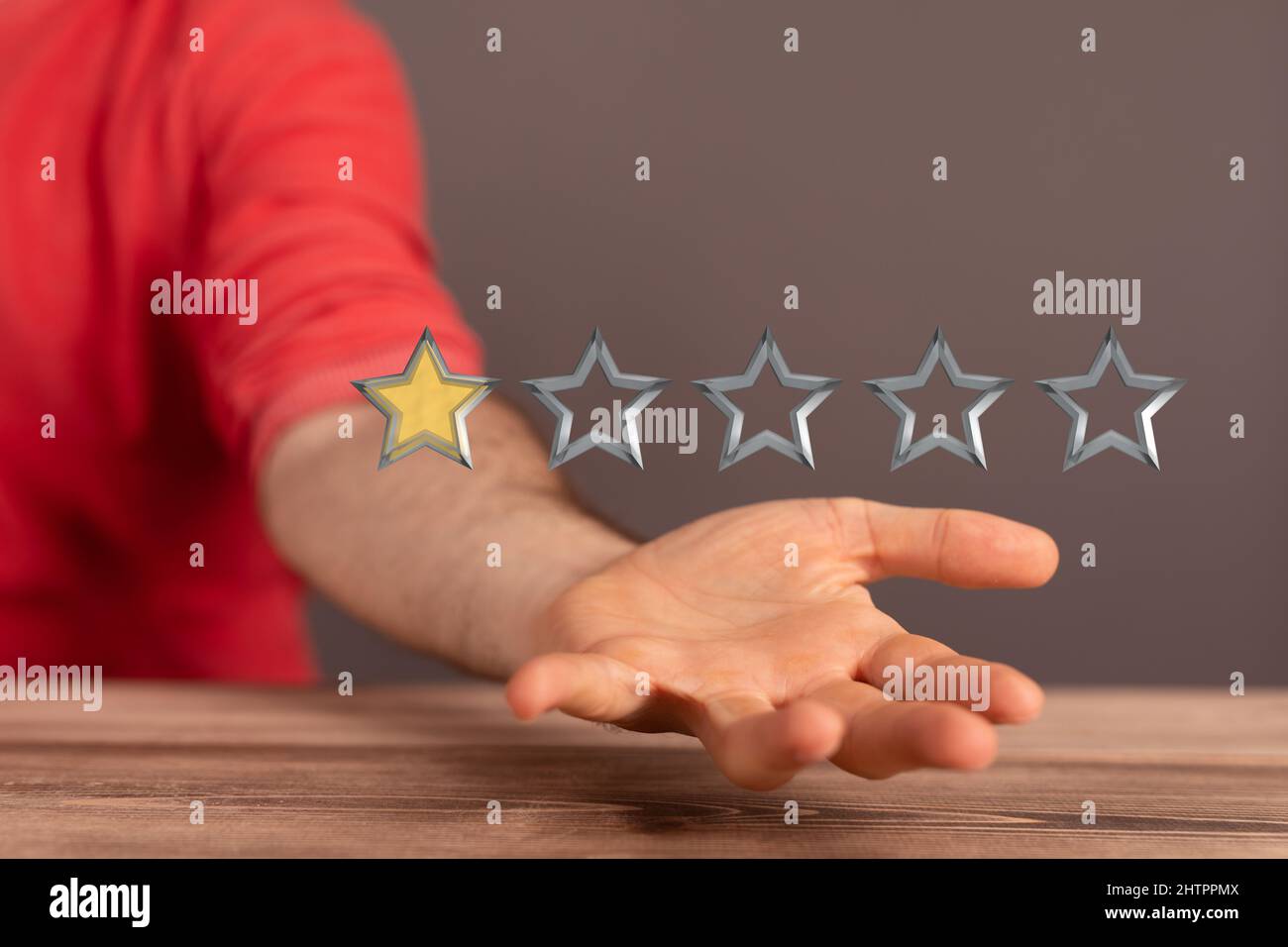 Hand holding one star rating sign Stock Photo - Alamy