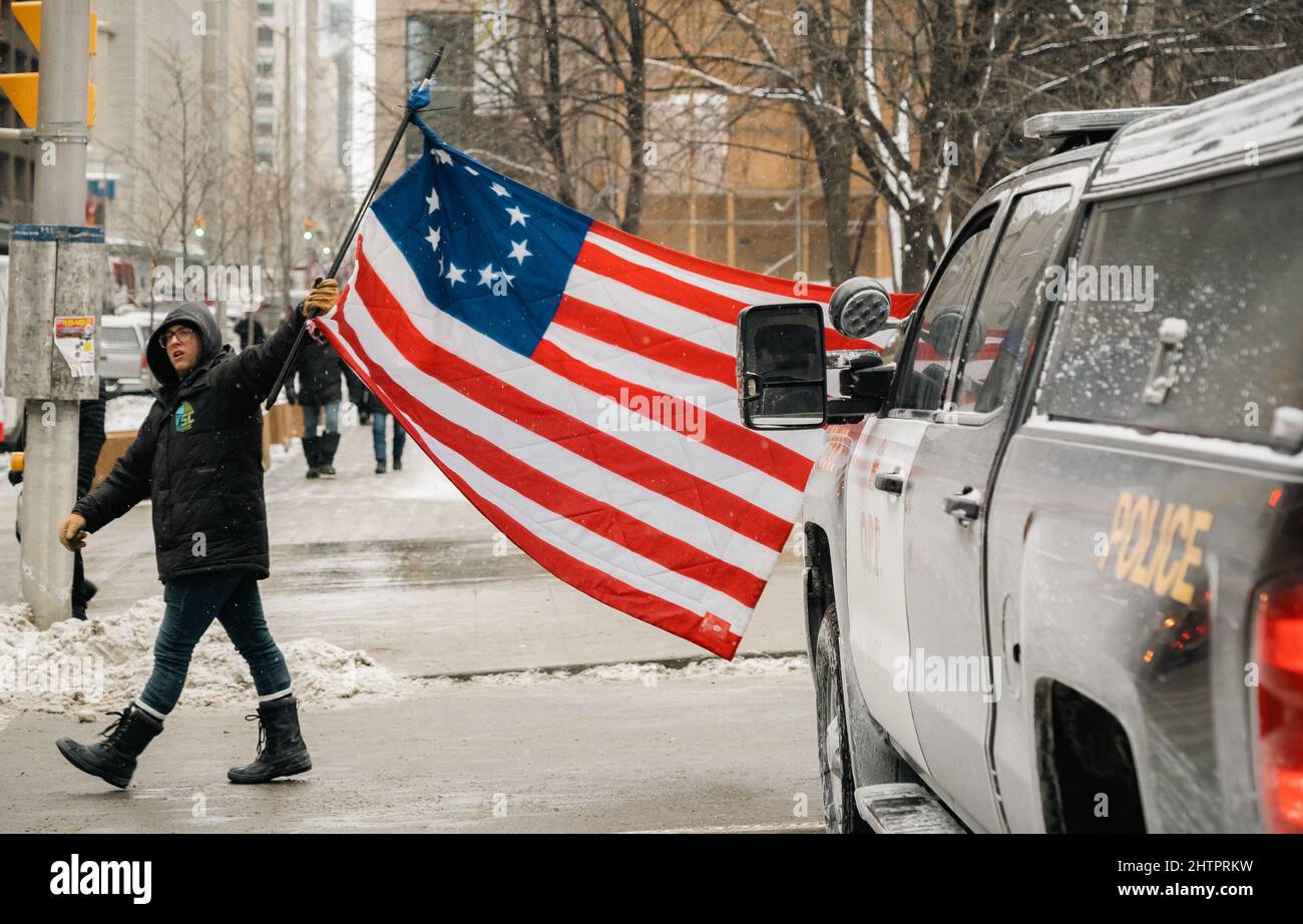 Protester waving a confederate flag in front of a police vehicle at ...