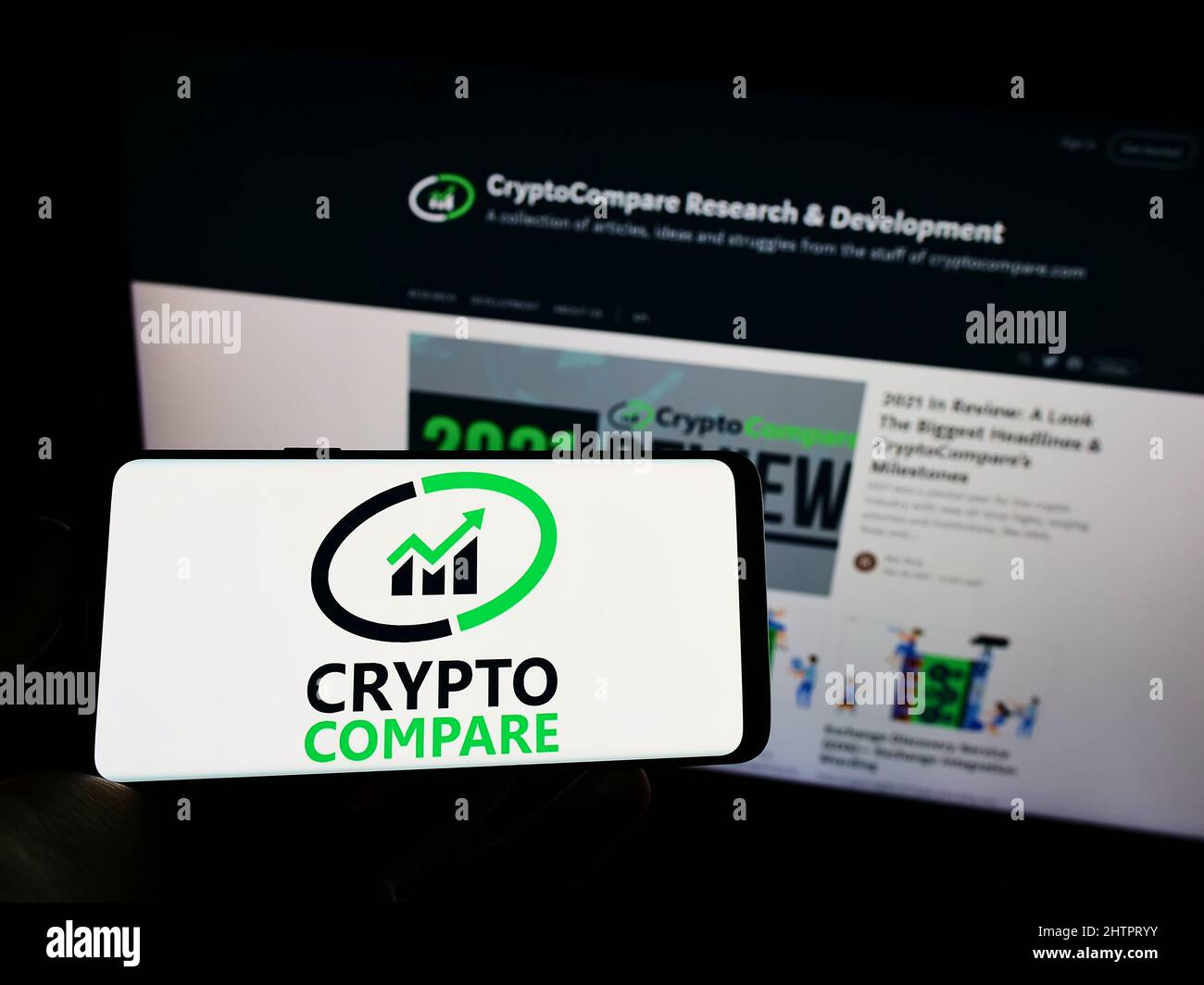 Person holding mobile phone with logo of British financial company ...