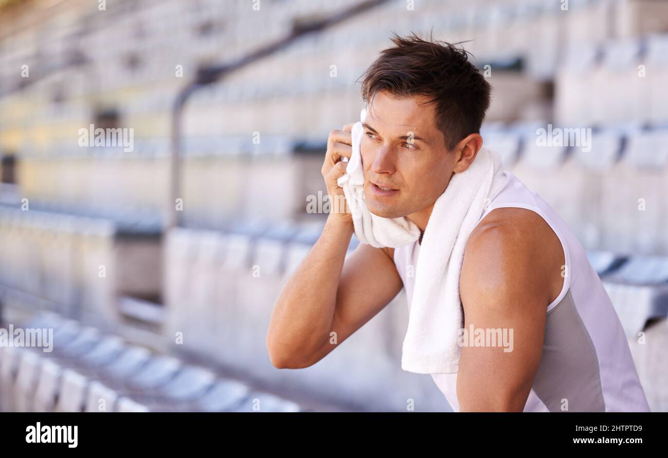 Sweating it out. Shot of an athlete taking a break from training Stock ...