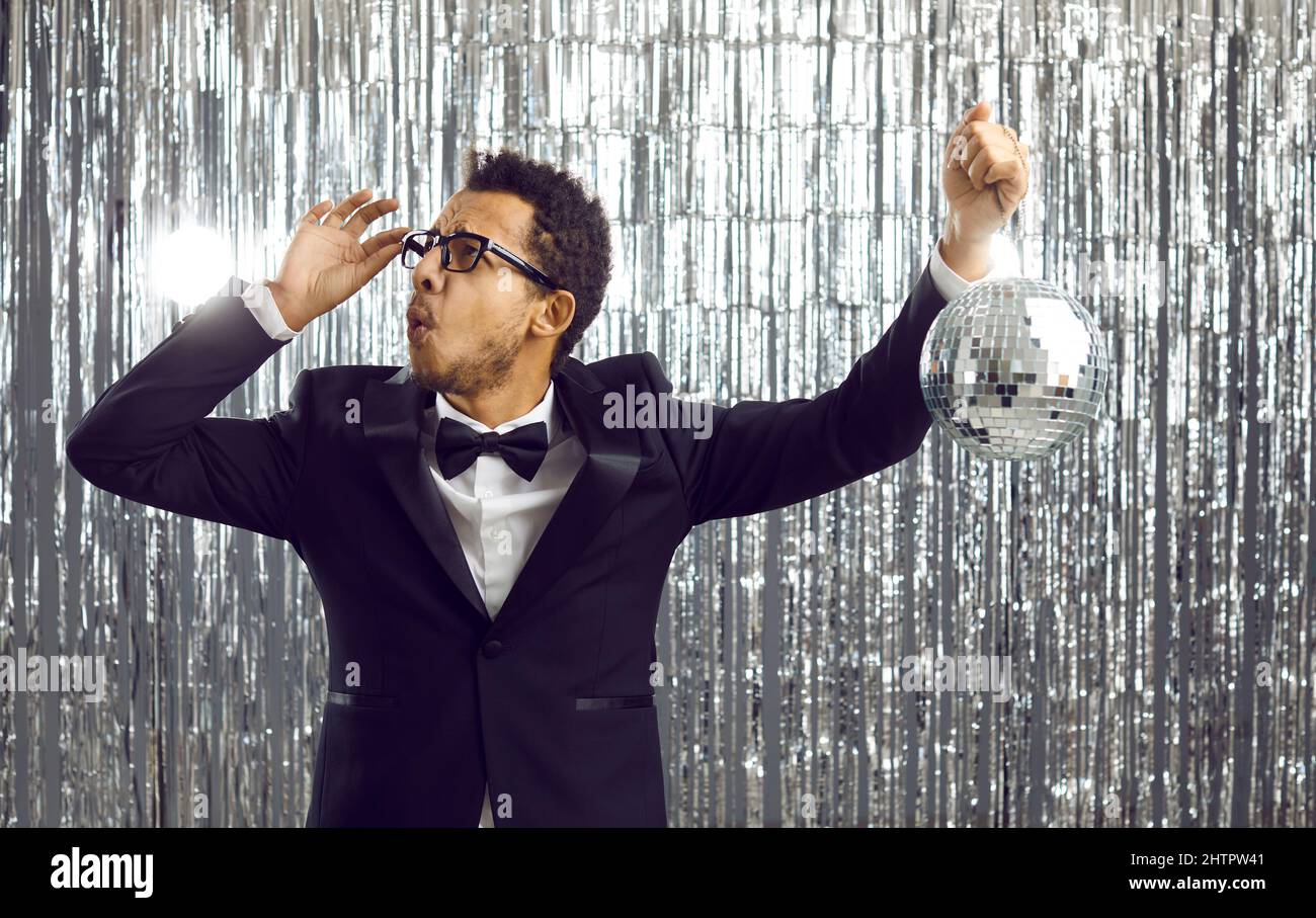 Positive young African American in elegant suit having fun at party ...
