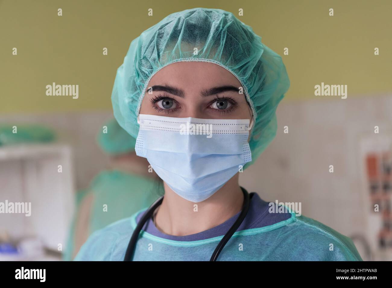 Portrait of sad and overwhelmed doctor wearing protective face mask ...