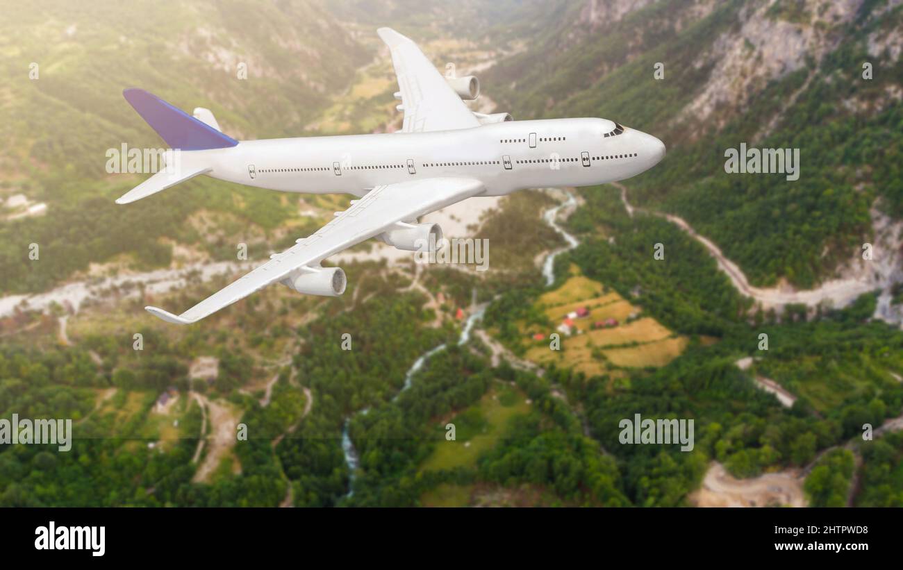 Aerial view of aircraft. Airplane is flying over mountains with forest ...