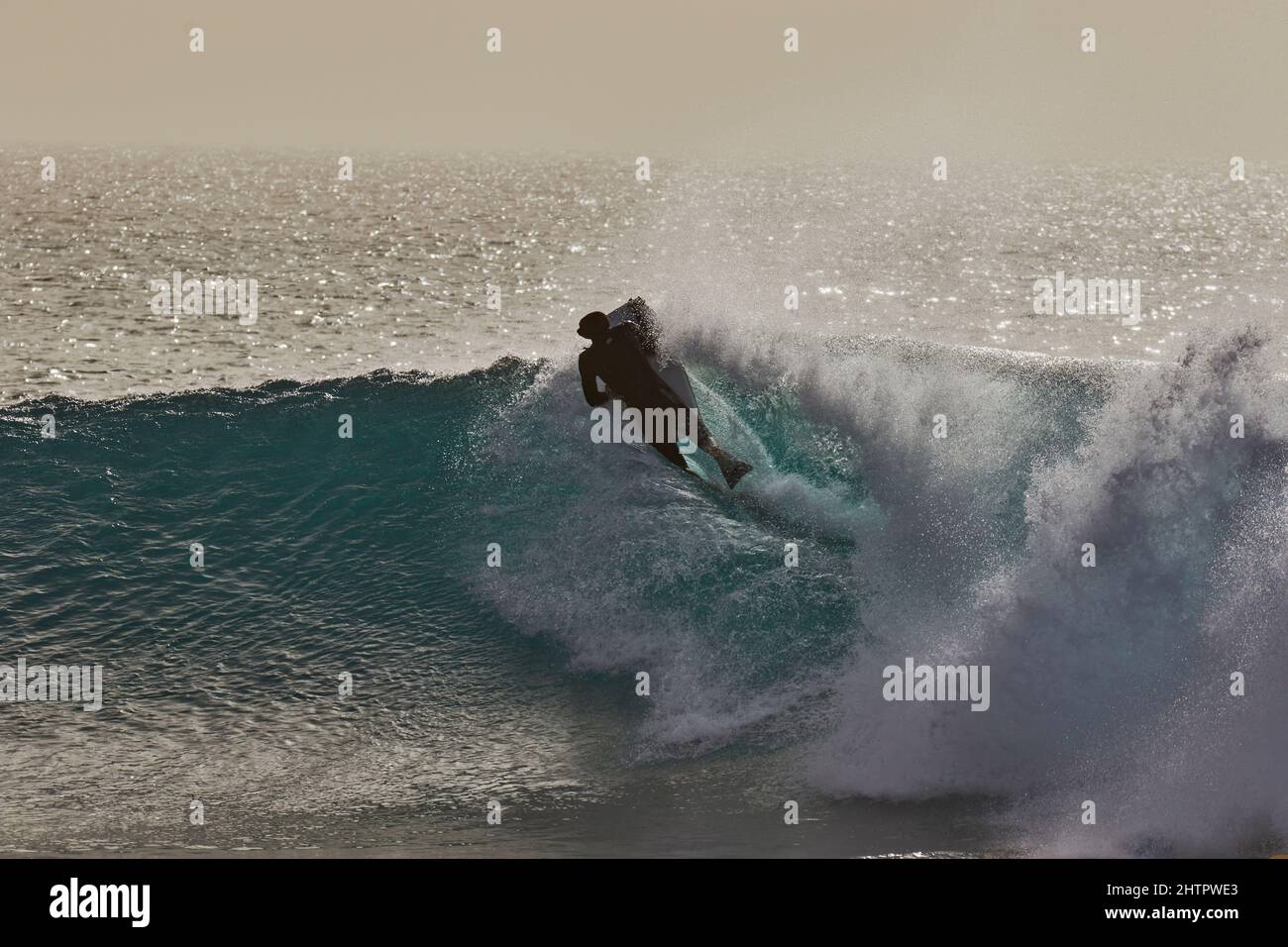 Surfing on Atlantic waves at Ponta Preta, southwest coast of Sal island ...