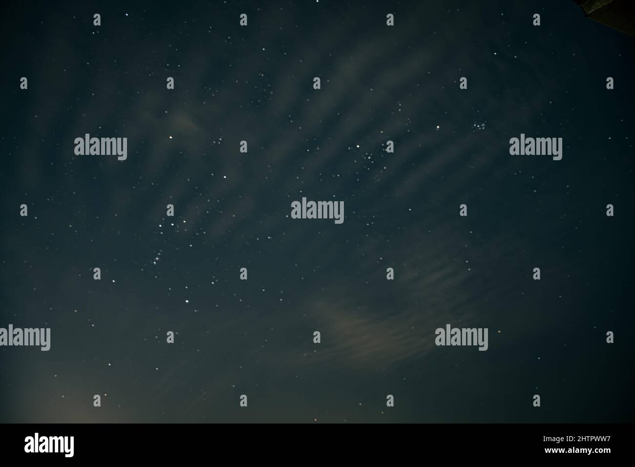 Dark starry night with thin layer of clouds Stock Photo - Alamy