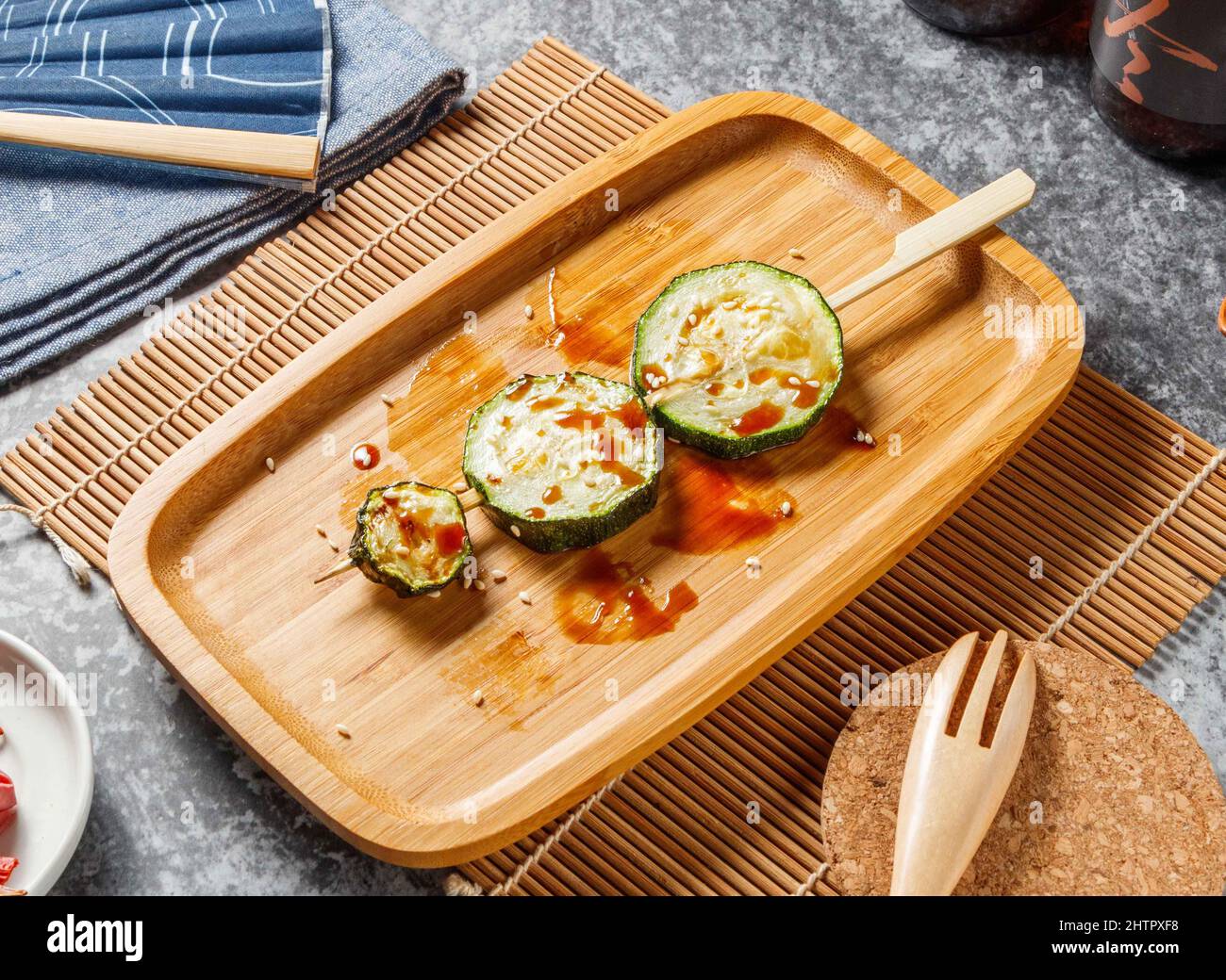 Pieces of melon love sticks in wooden dish isolated mate and grey ...