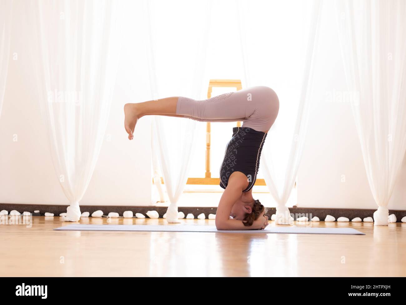 Young woman doing urdhva dandasana pose or upward facing staff pose ...
