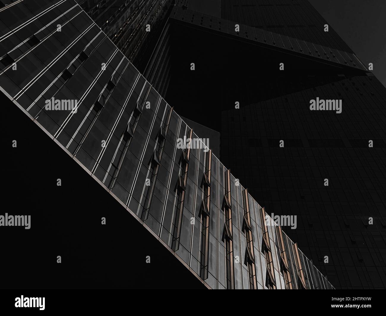 Low angle shot of an office building at night with open windows Stock ...
