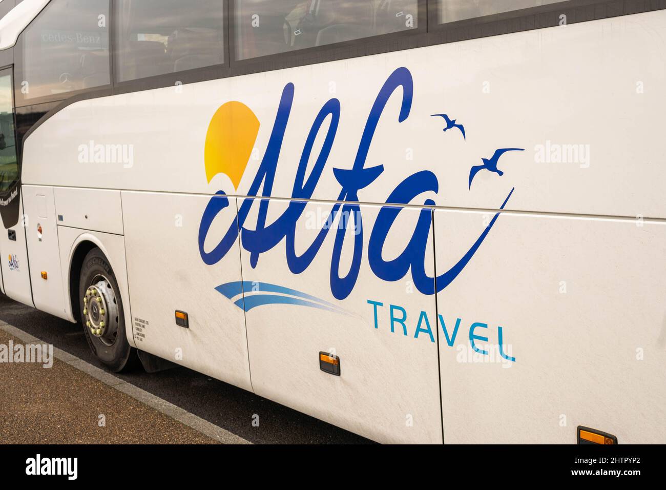 Alfa Travel coach parked on side of road Stock Photo - Alamy