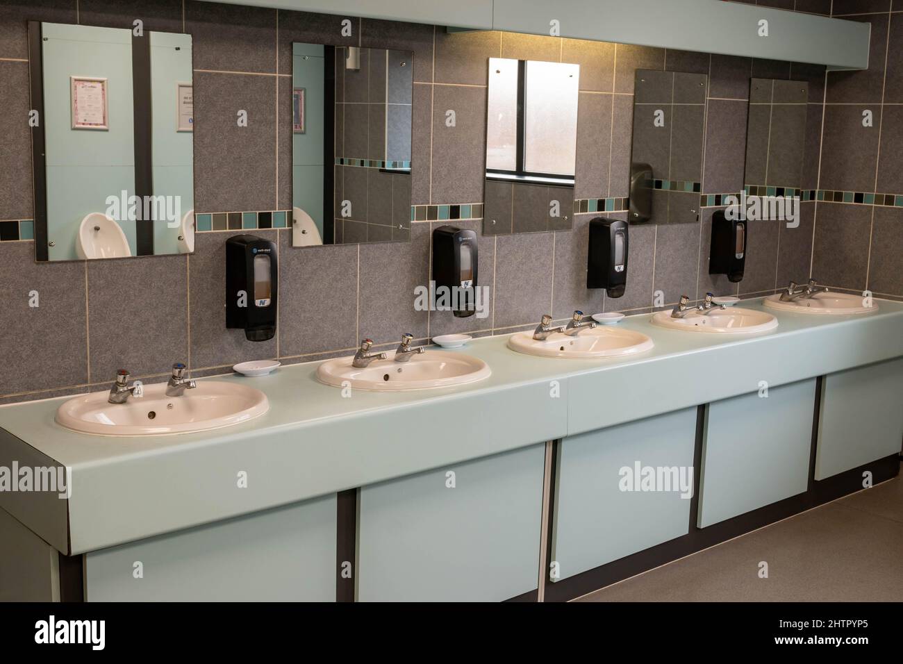 Row of sinks in a mens toilet in England Stock Photo - Alamy