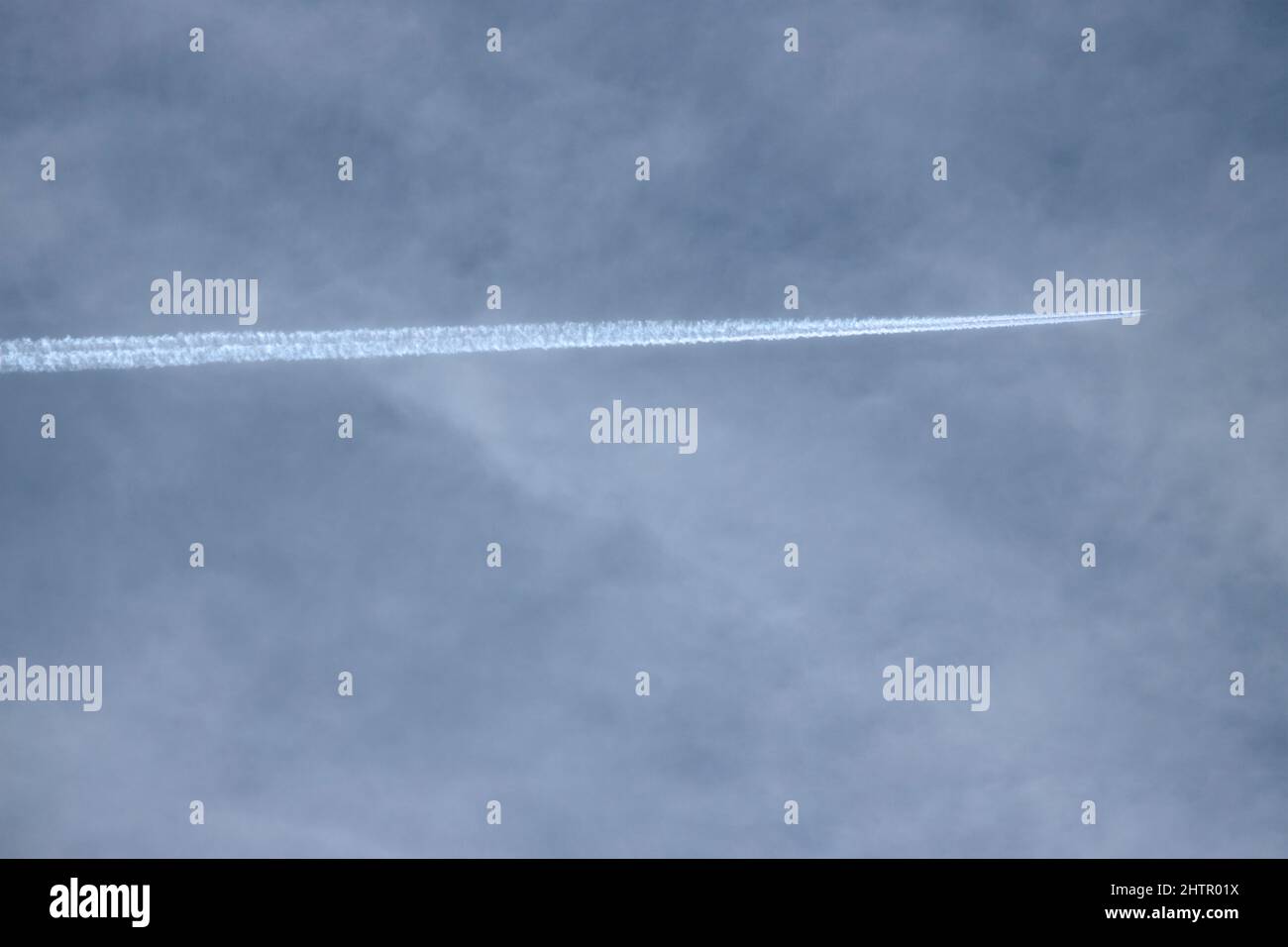 A high altitude passenger jet leaves a contrail in the upper atmosphere ...