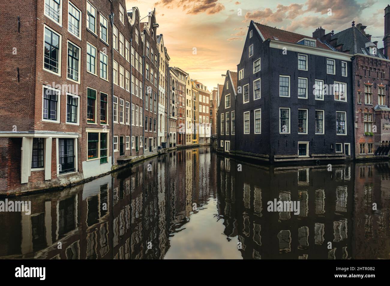 View of city buildings in water reflection under the bright sky in ...