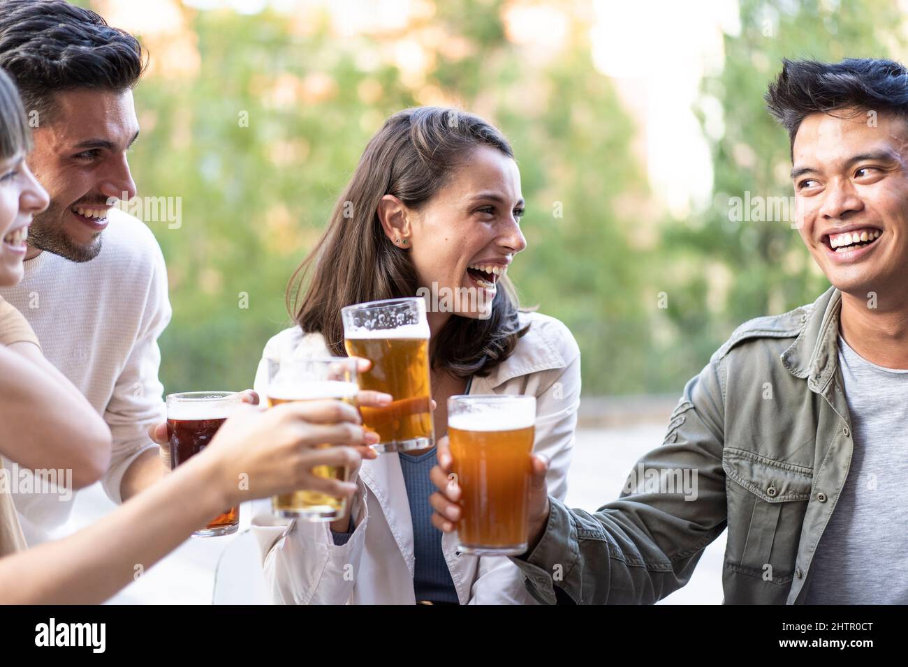 Happy multiracial friends group drinking beer at brewery pub restaurant ...