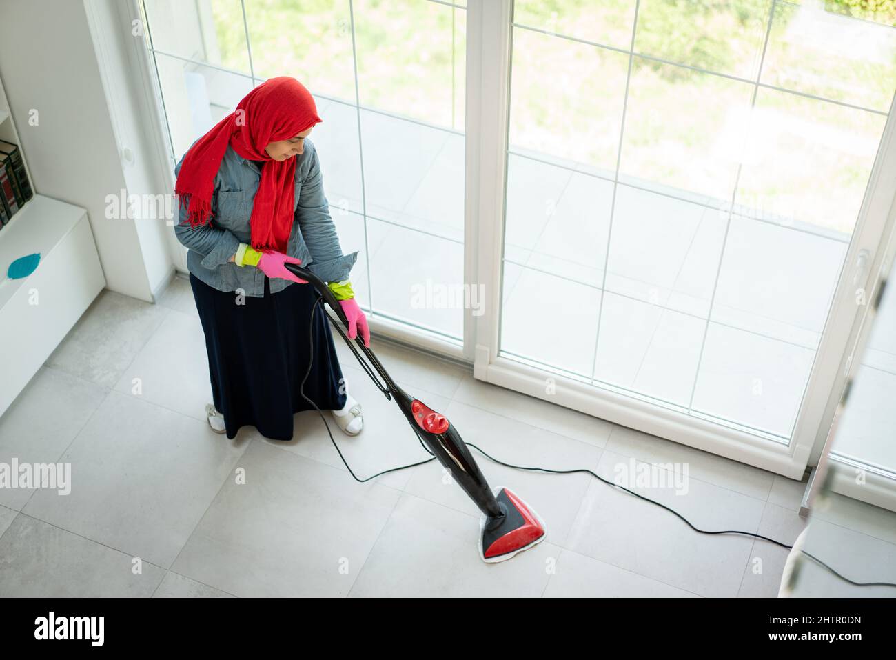 Happy Muslim Woman Cleaning Modern House Living Room. High quality ...
