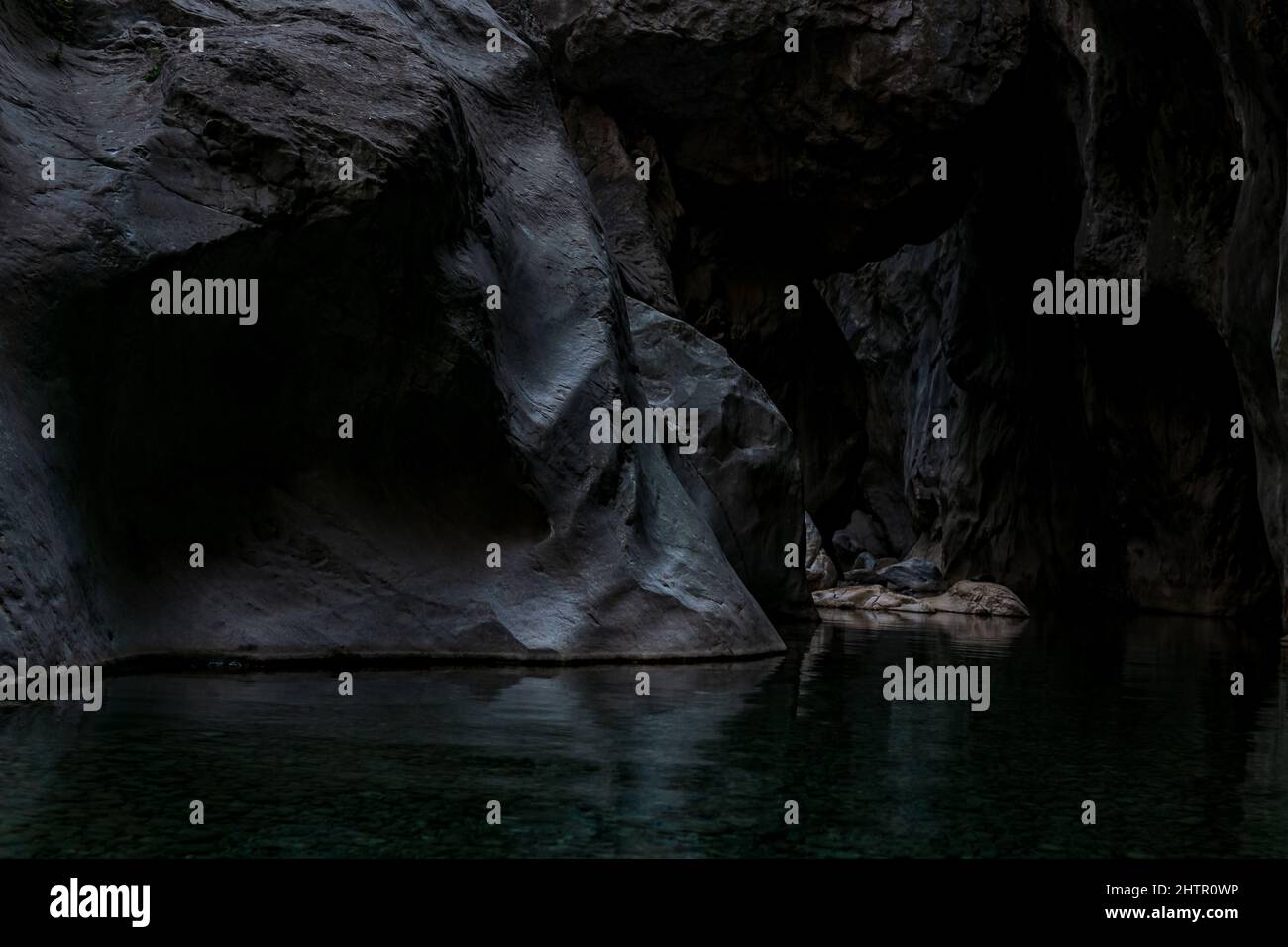 clean underground cave river in steep stone banks in the dark Stock ...