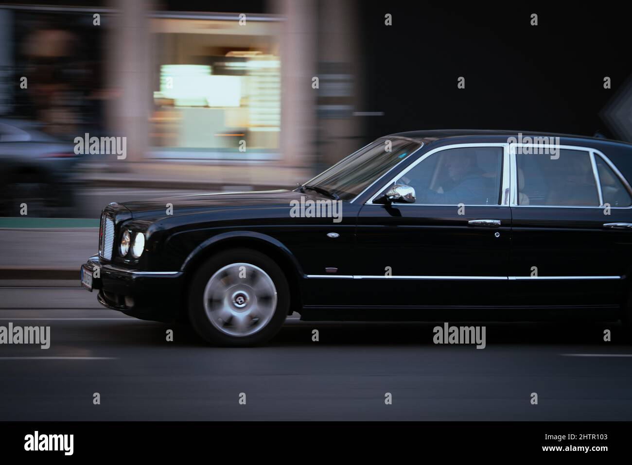 Long exposure of a black classic car on the road Stock Photo - Alamy