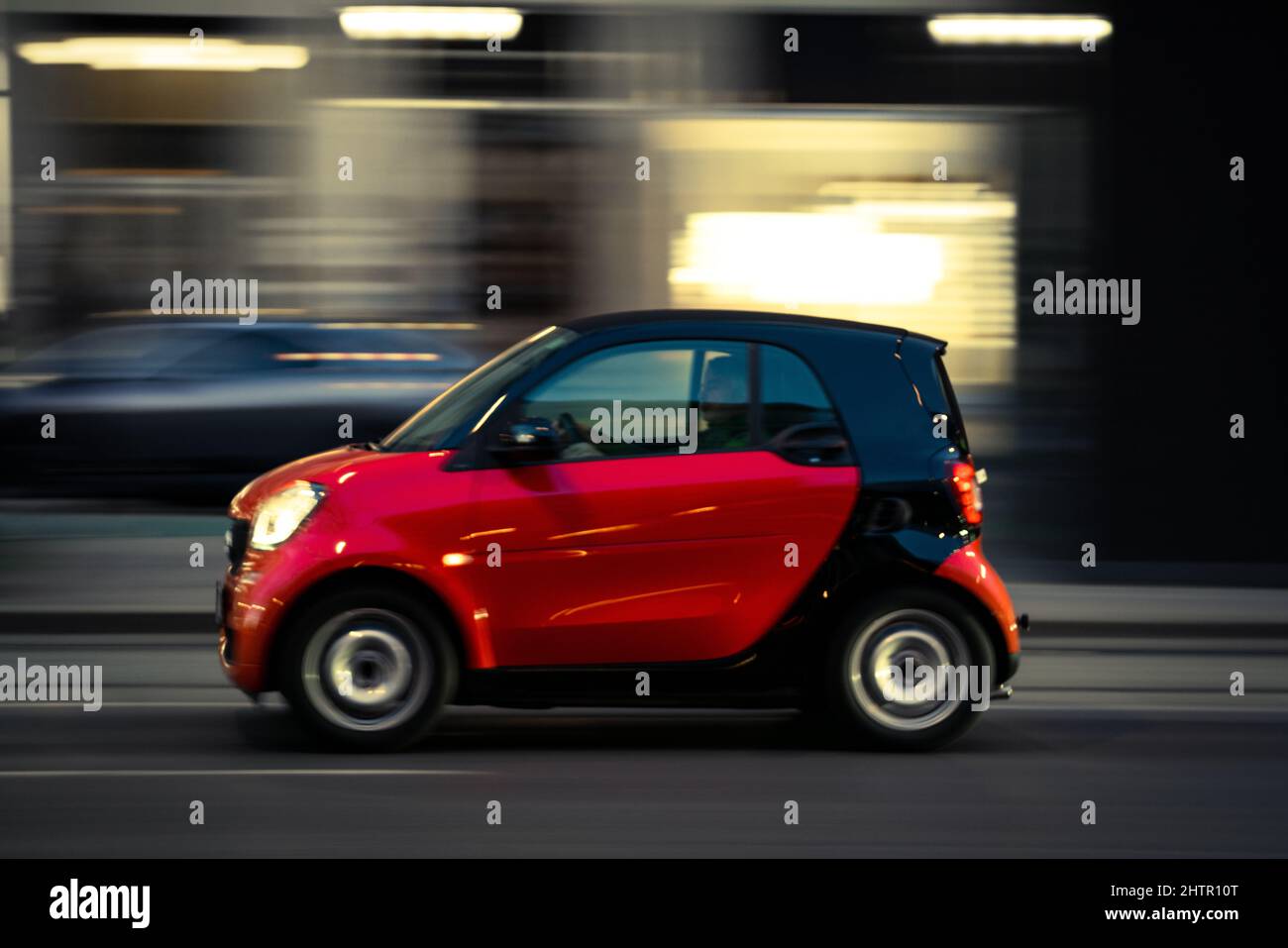 Selective of a miniature red car in long exposure Stock Photo - Alamy