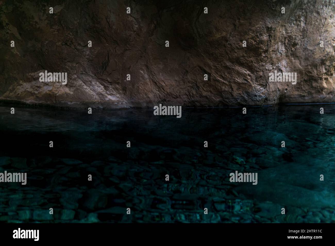 clean underground cave river in steep stone banks in the dark Stock ...