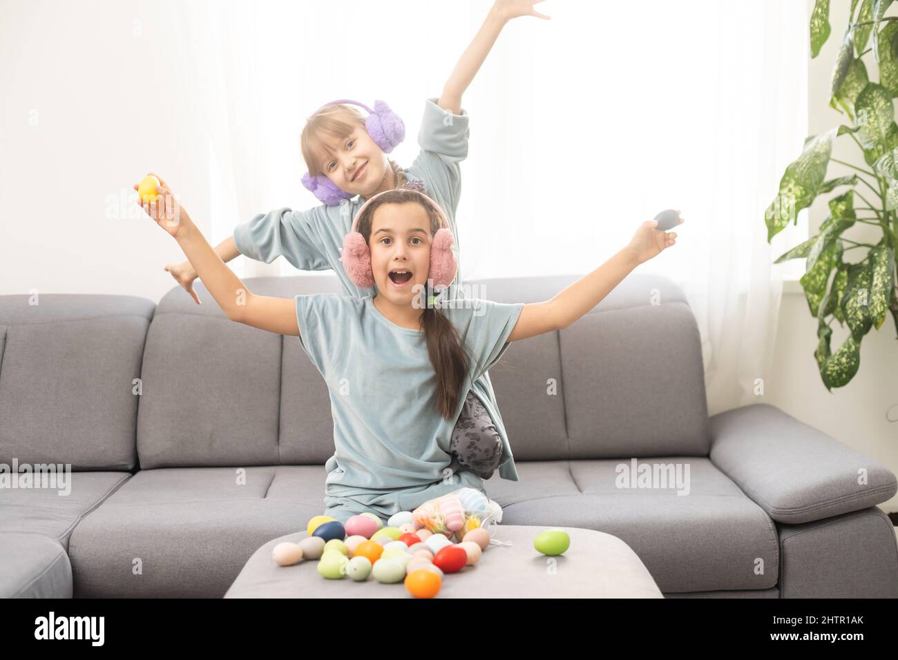 Funny little girls with Easter eggs Stock Photo - Alamy