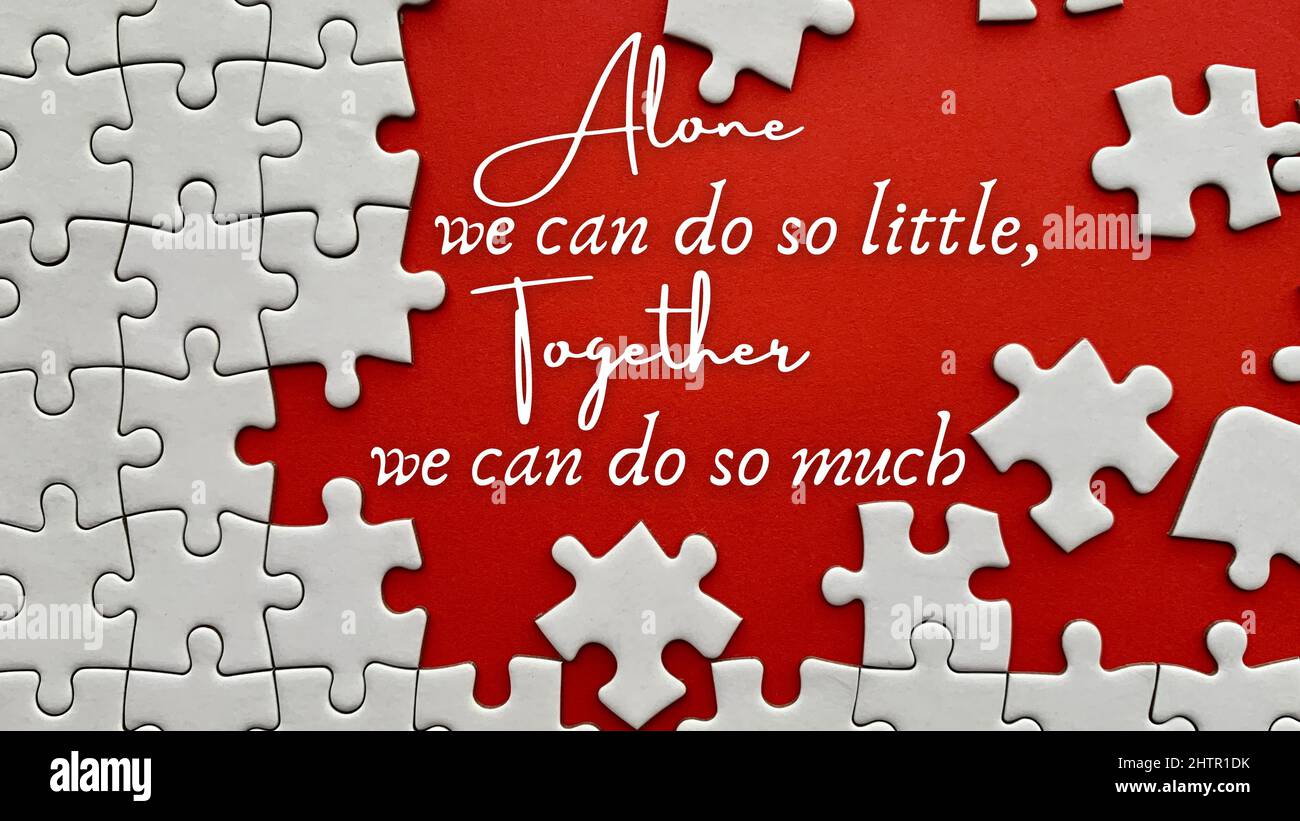 Top view of teamwork inspirational quote on red cover with jigsaw ...
