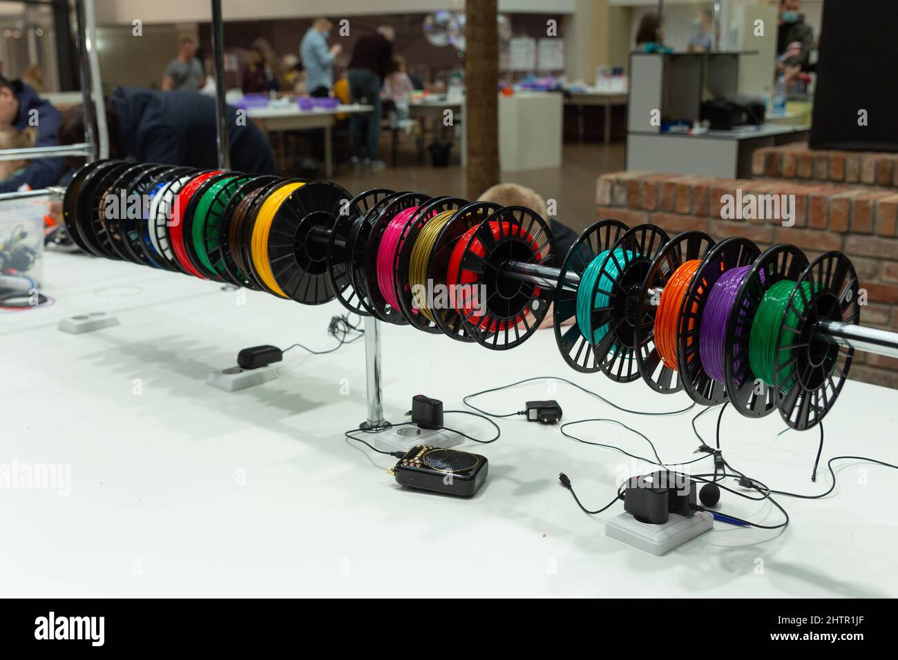 Visitors to the exhibition of modern technologies test 3D pens on a ...