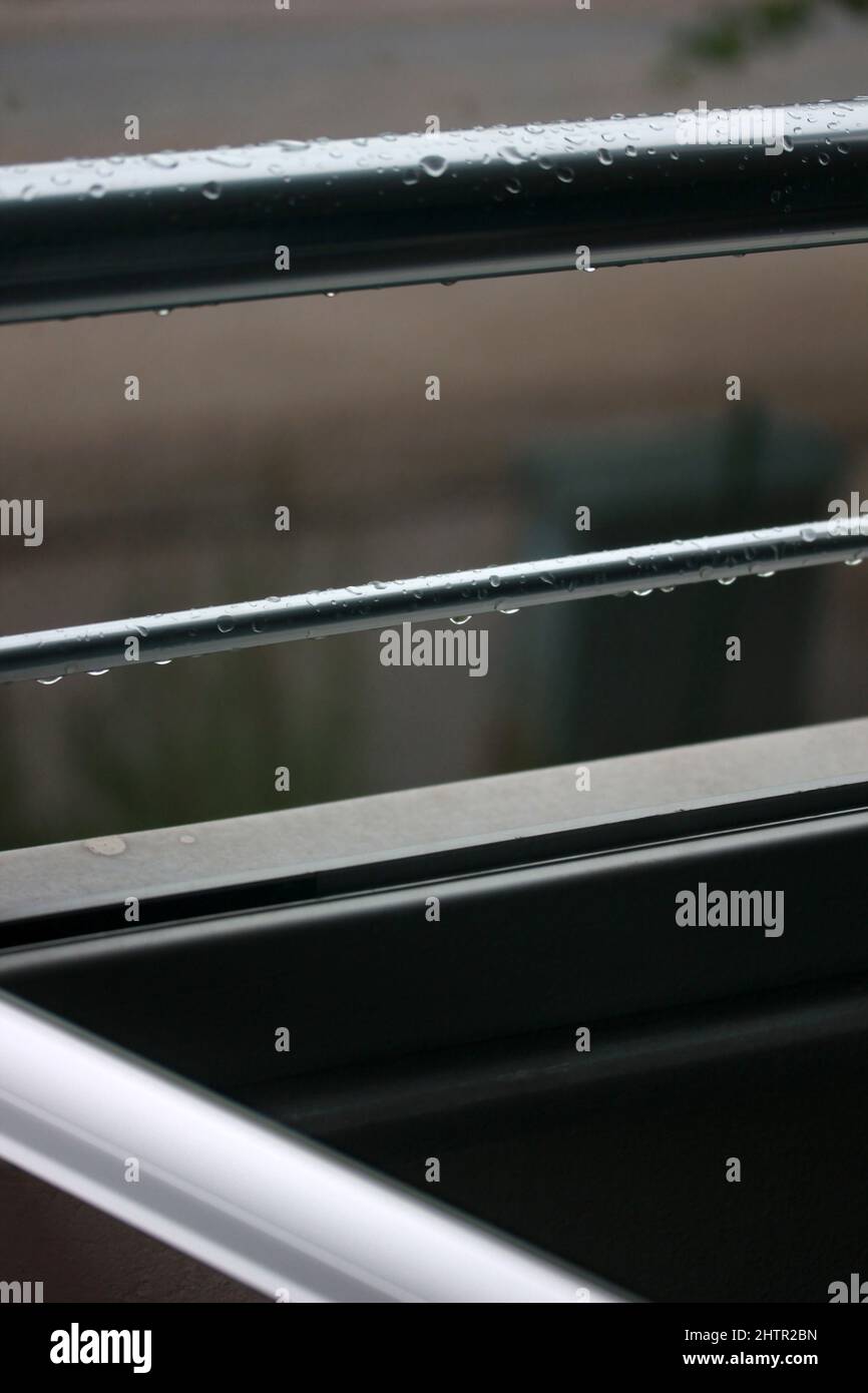 raindrops falling on aluminum railing Stock Photo - Alamy