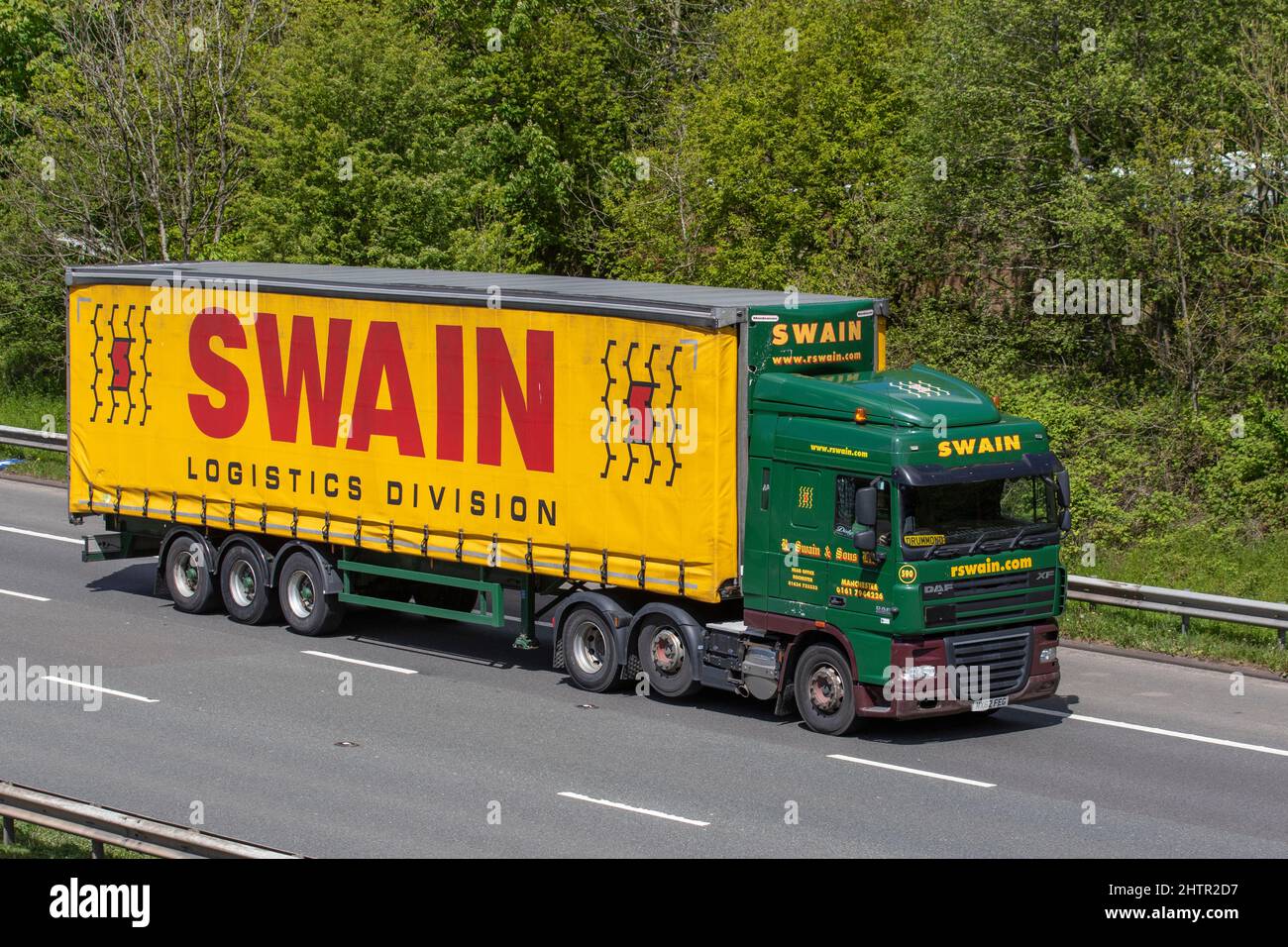 Swain Logistics Division DAF XF curtain-side lorry driving on the M61 ...