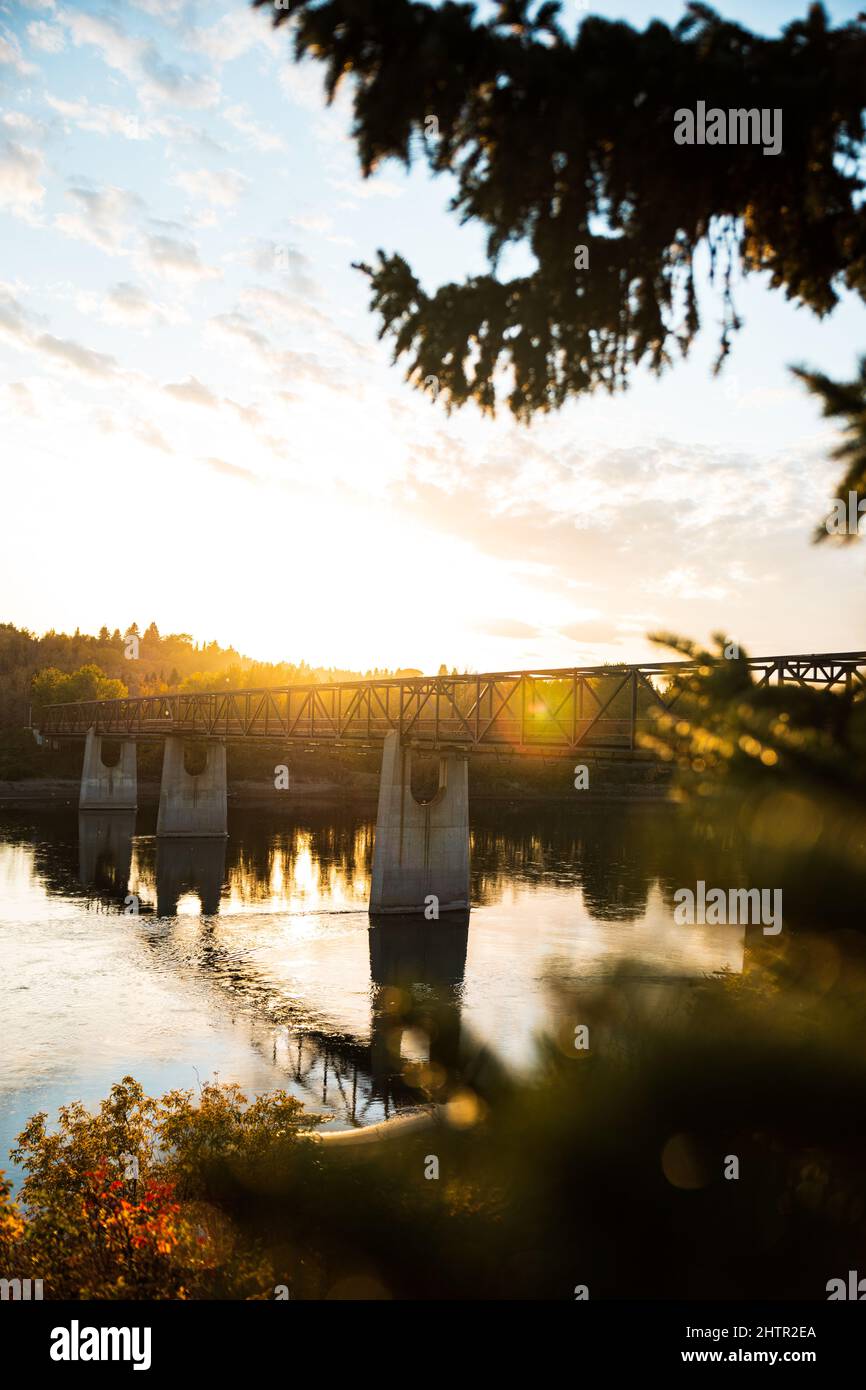 Long bridge over the river in a park on the sunset Stock Photo - Alamy