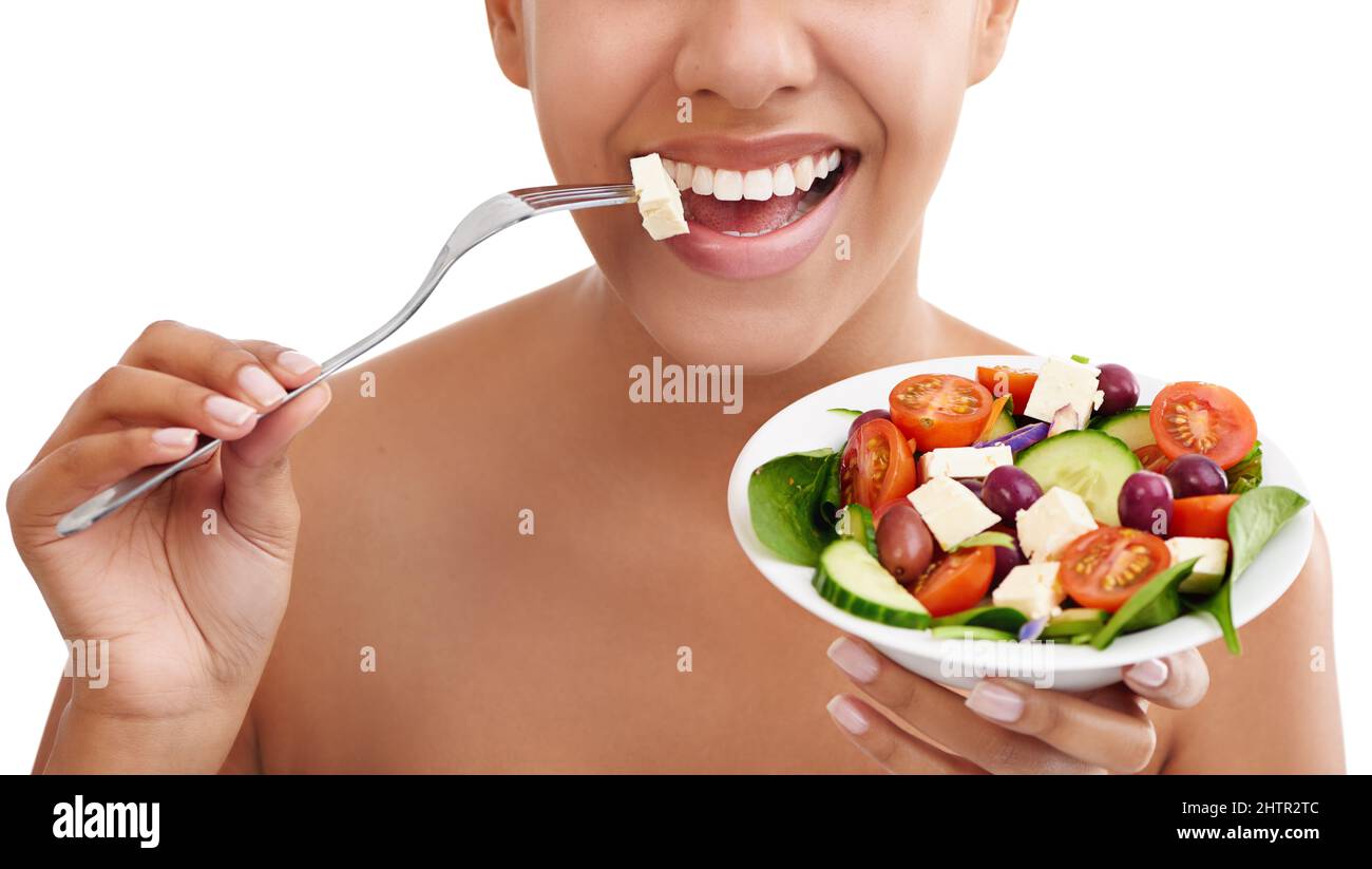 Sticking to a salad today. Cropped studio shot of a woman eating a ...