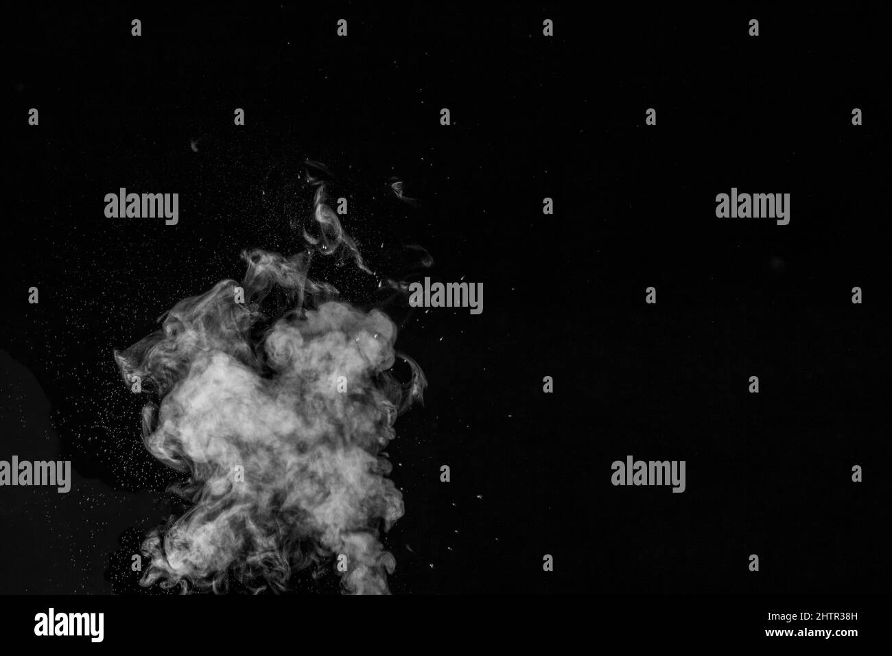 Curly white steam rising up and splashing water scattering in different ...