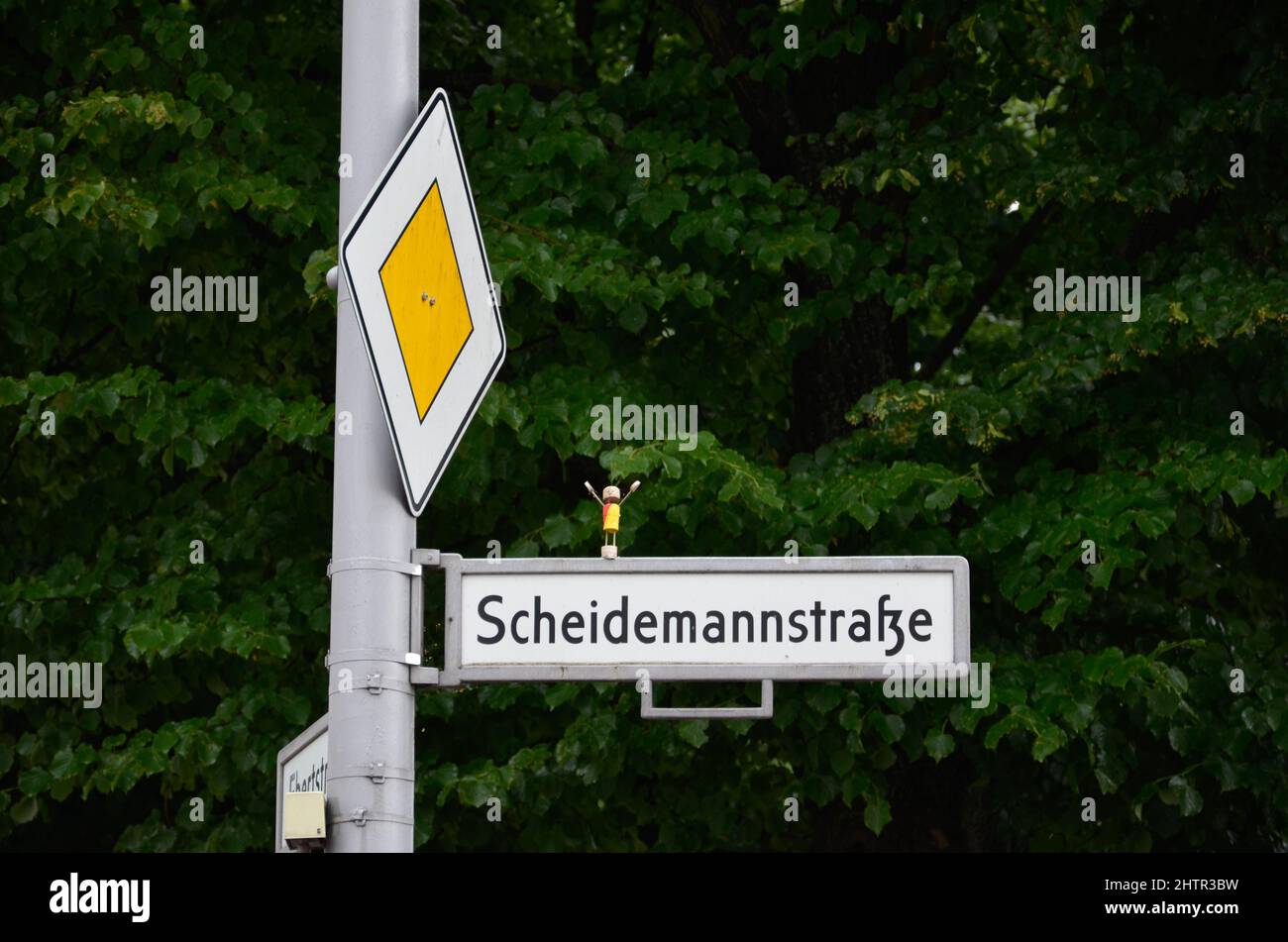 Berlin street sign of Scheidemannstraße with small cork man on it and a ...