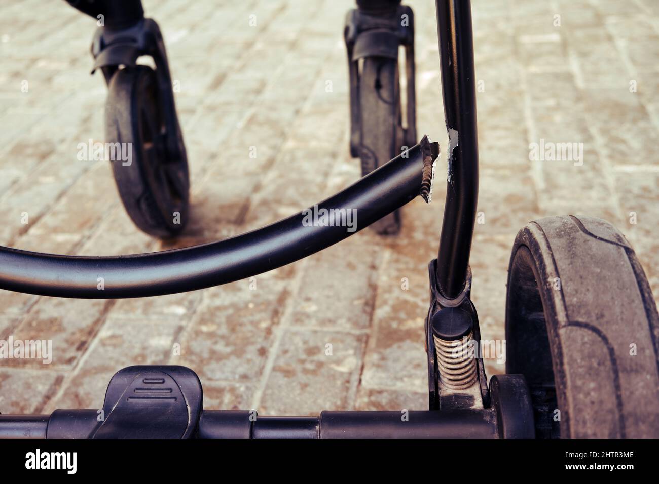 Broken chassis of a baby stroller, damage to the crossbar of the metal ...