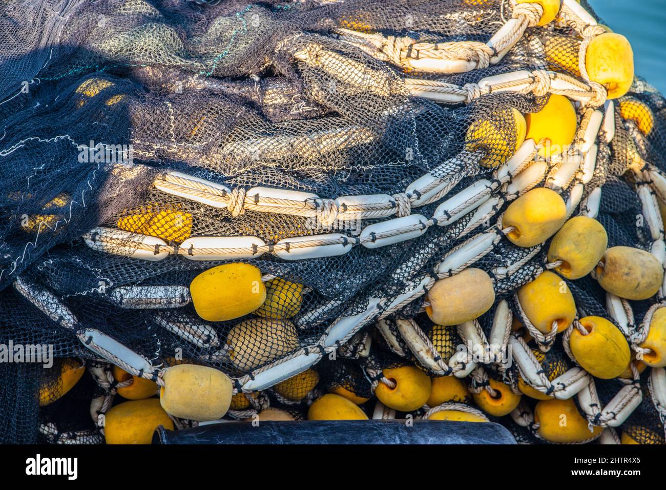 A fishing net with ropes and cord on the deck of a Fisherman's boat ...