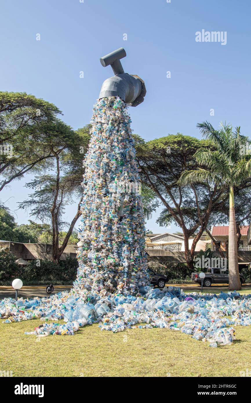People are seen next to a plastic waste art installation by Canadian ...