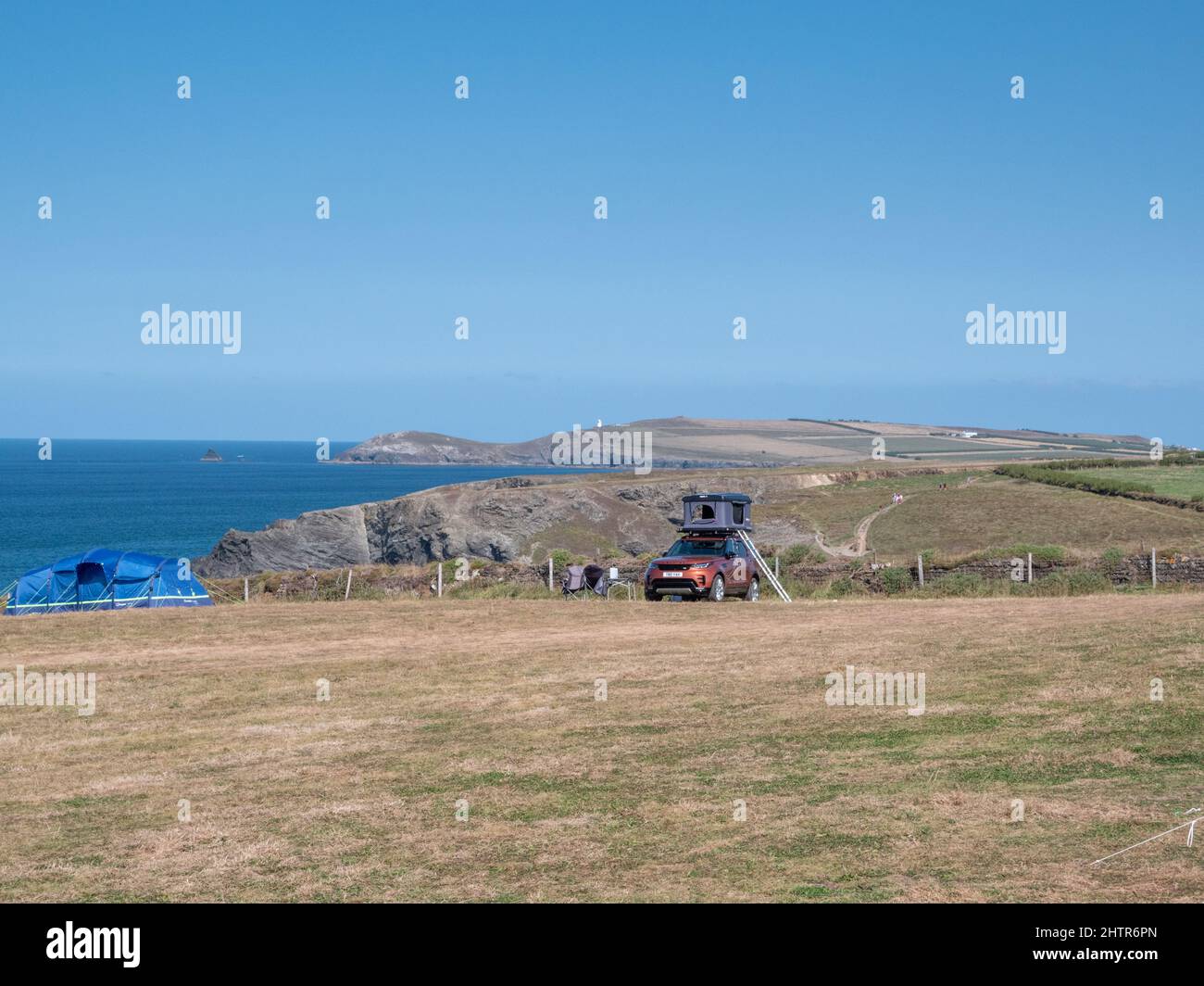 A campervan parked on a cliff top site in Porthcothan Bay Cornwall UK ...