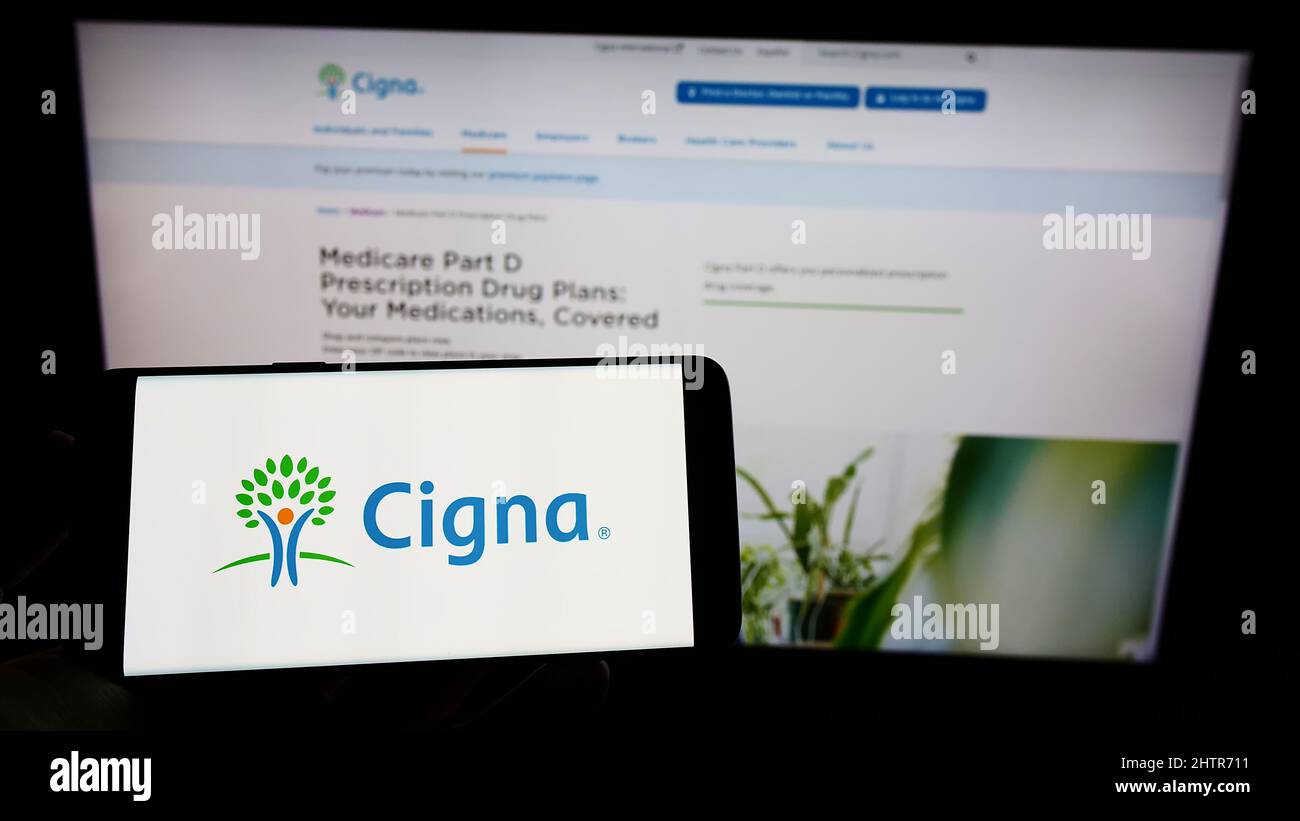 Person holding cellphone with logo of American health insurance company ...