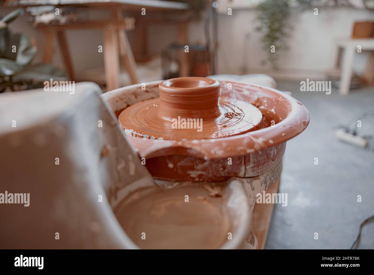 Raw clay product on potter wheel in workshop Stock Photo - Alamy