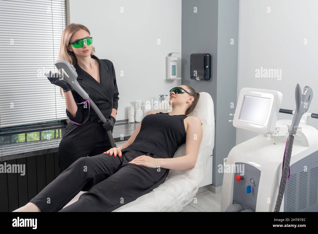Young woman receiving laser treatment in cosmetology clinic Stock Photo ...
