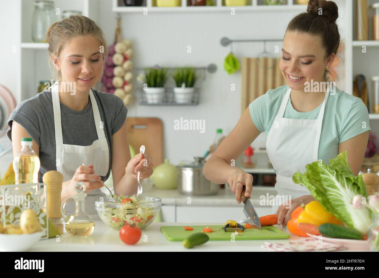 Portrait of beautiful teenagers cooking in kitchen Stock Photo - Alamy