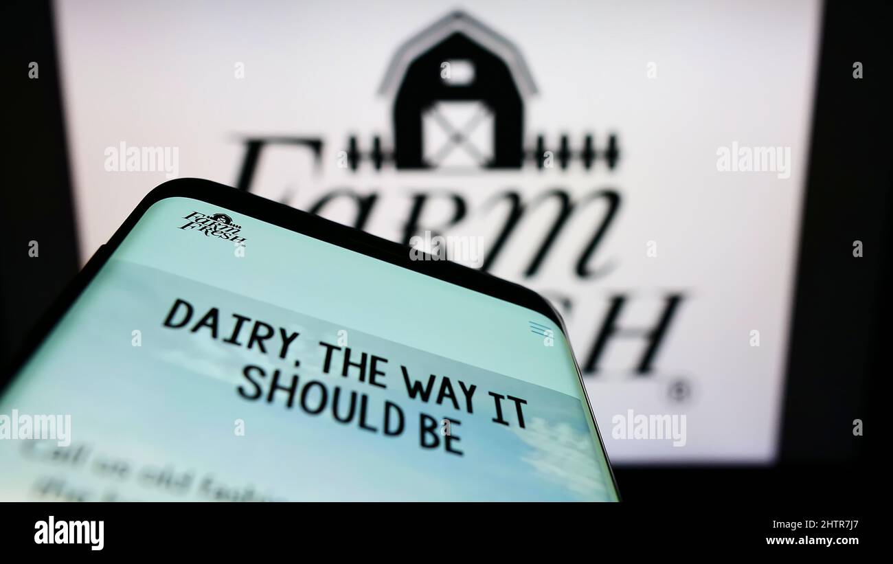 Mobile phone with webpage of Malaysian dairy company Farm Fresh Berhad ...