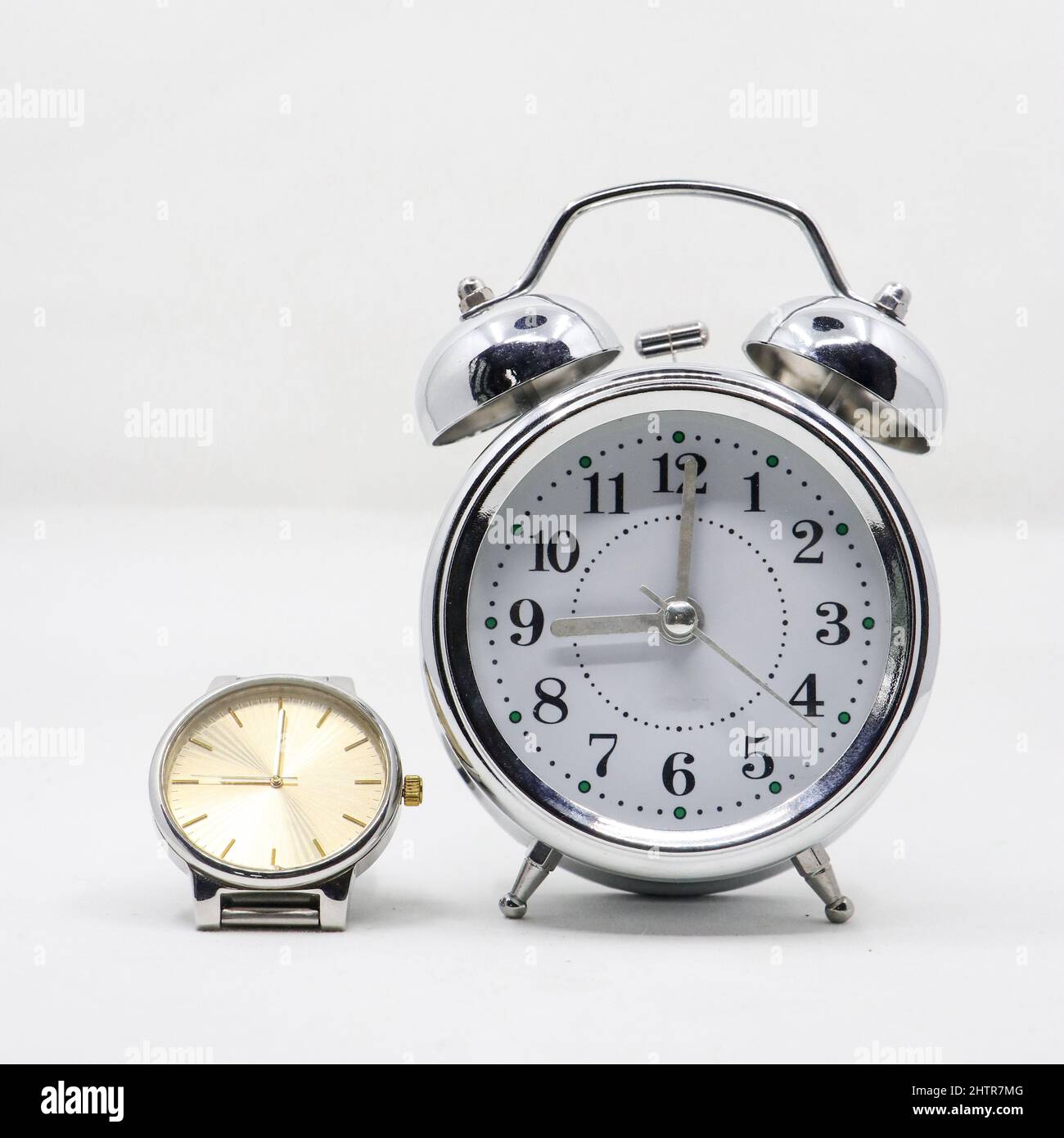 Photo of a watch and an alarm clock on a white background Stock Photo ...