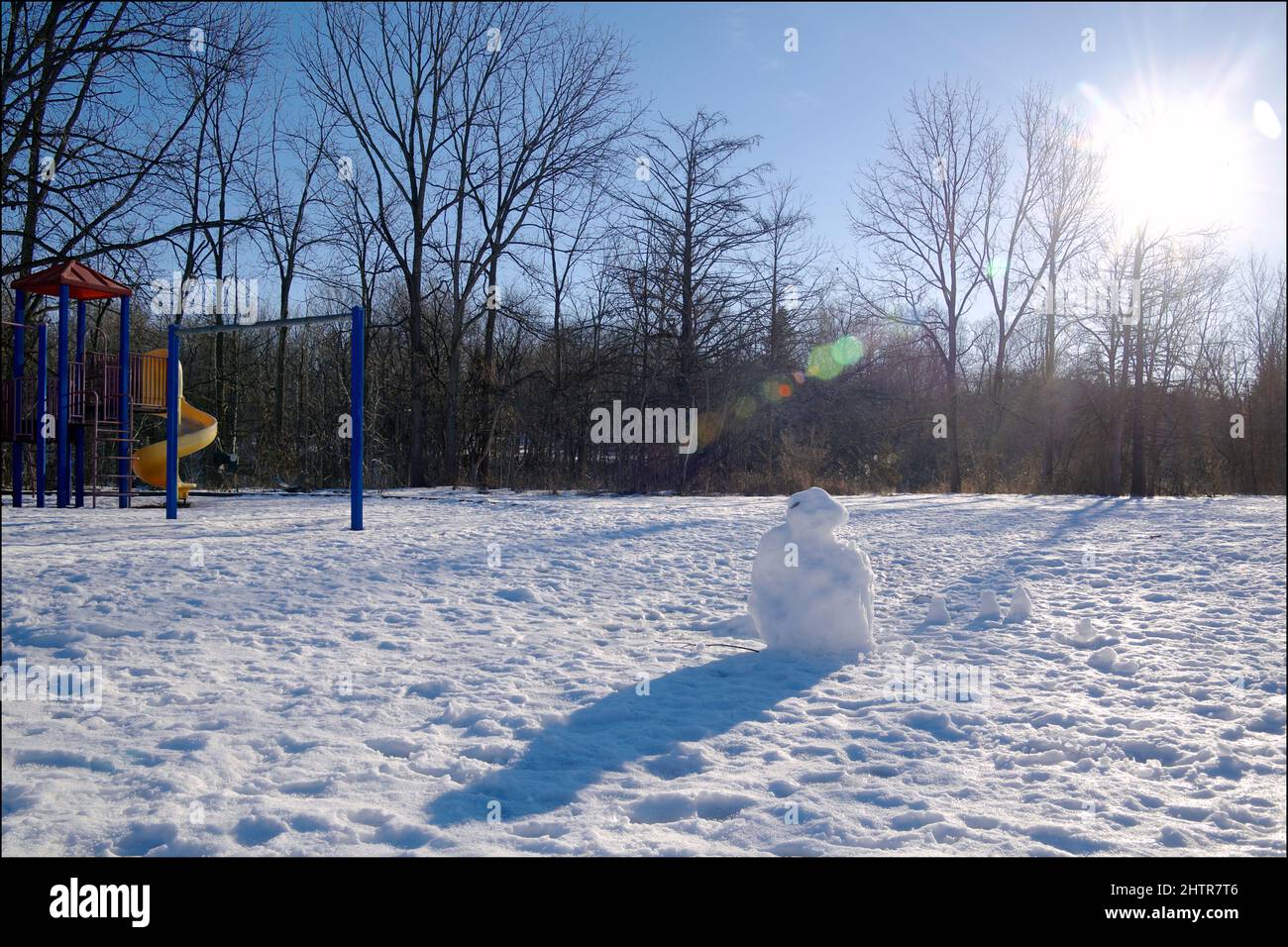 Snowman on a public park in winter with lens flare Stock Photo - Alamy