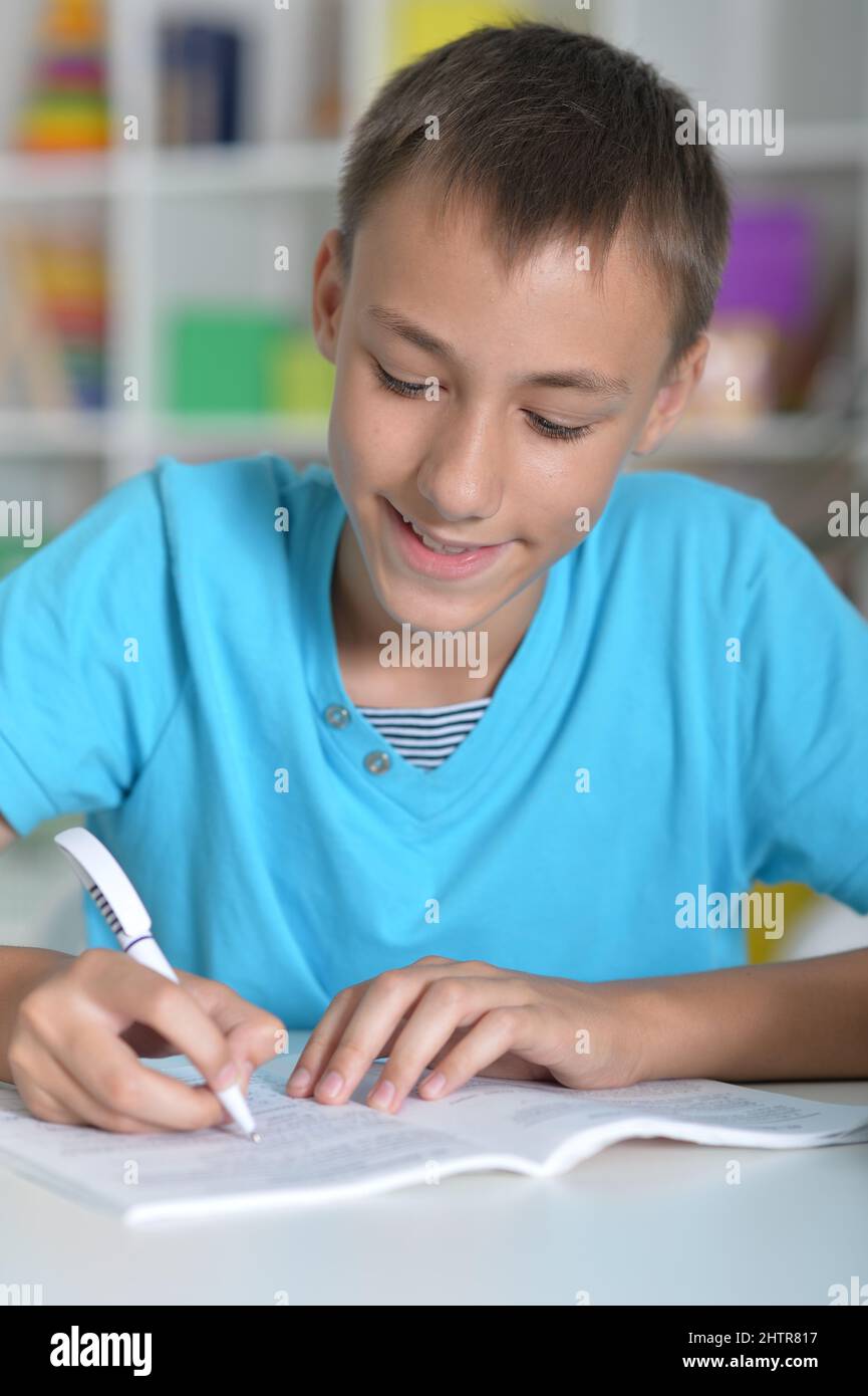 Portrait of cute boy doing homework at home Stock Photo - Alamy